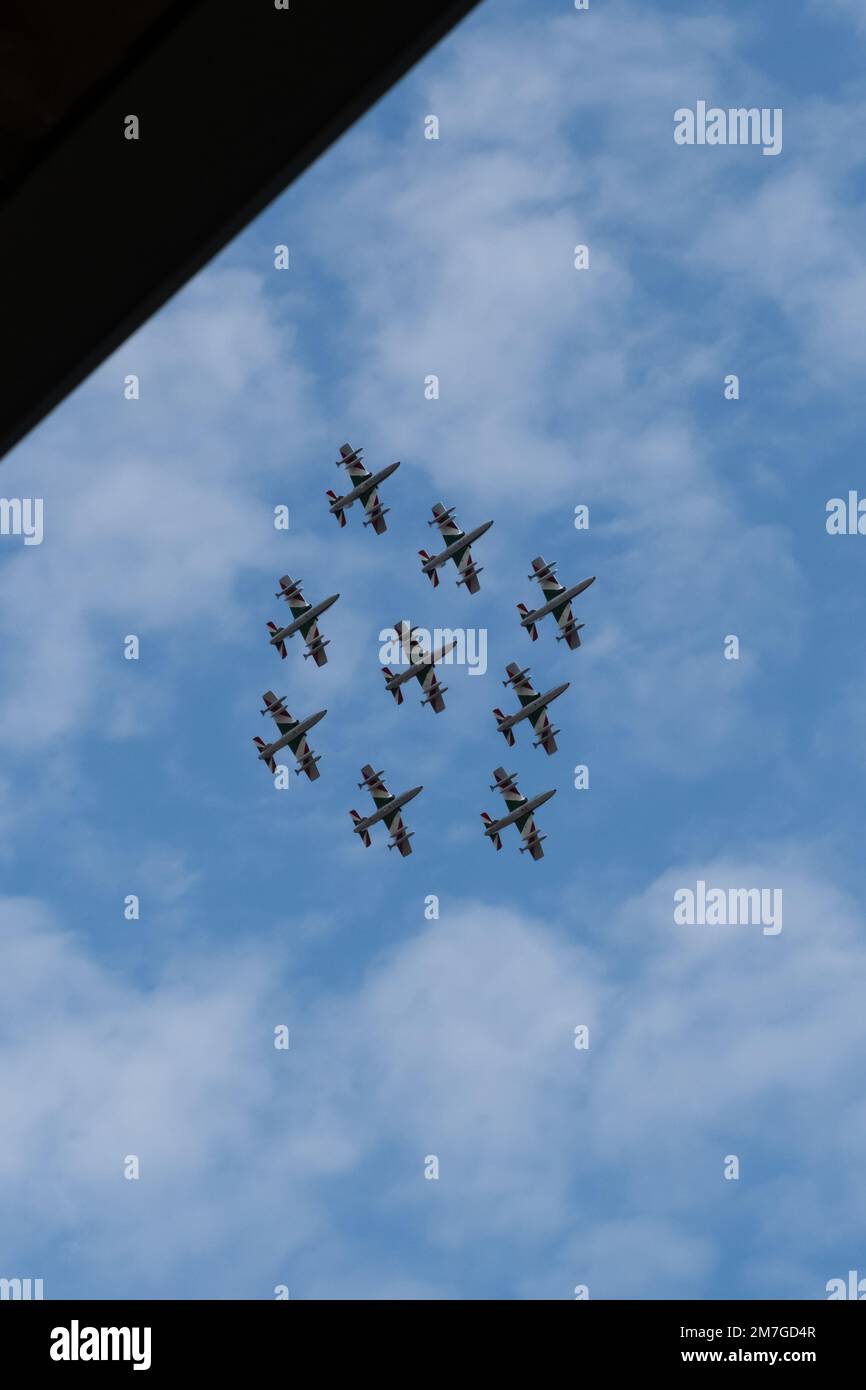 A vertical shot of multiple aircraft jets performing stunts in the air ...