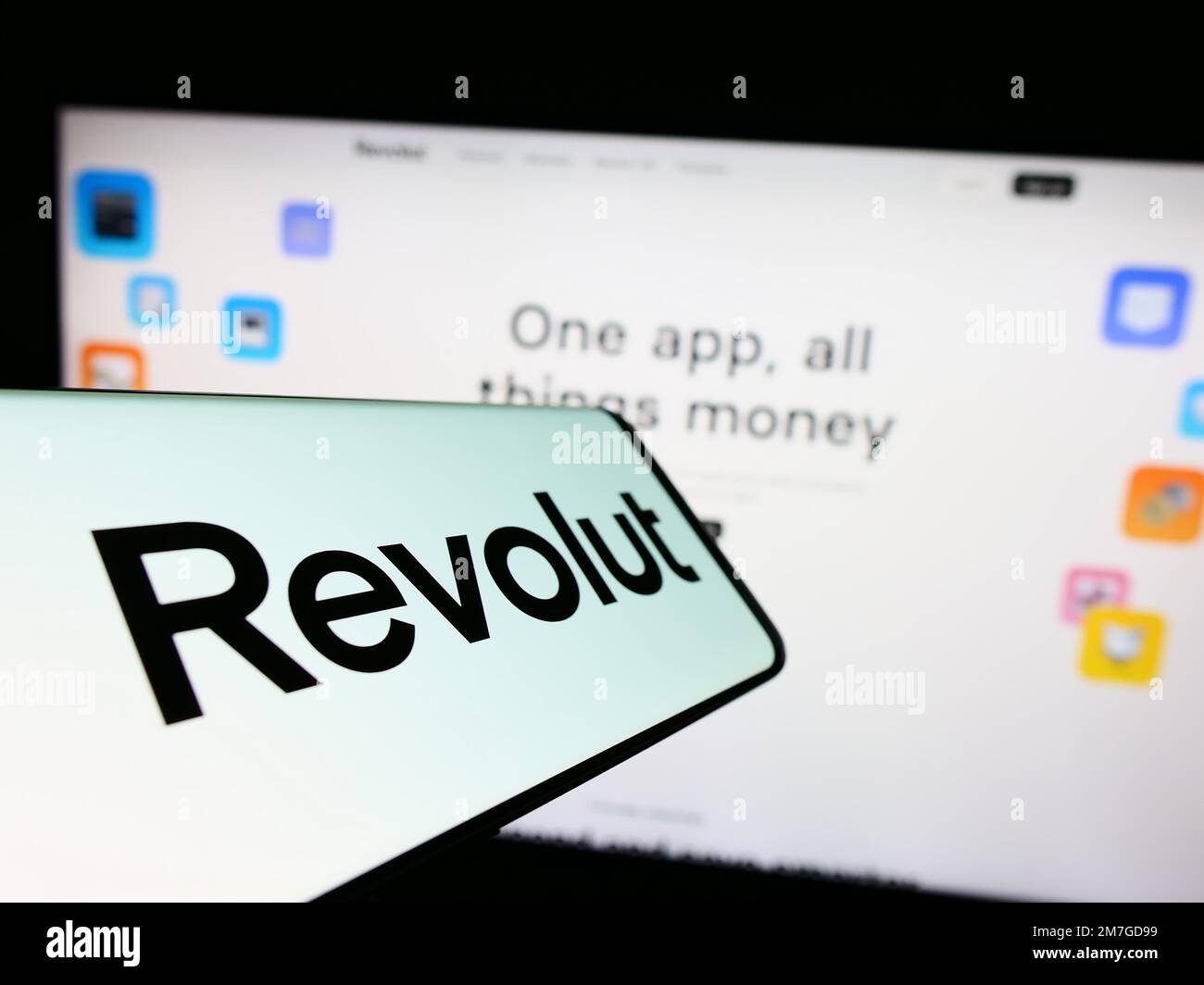 Smartphone with logo of British fintech company Revolut Ltd. on screen ...