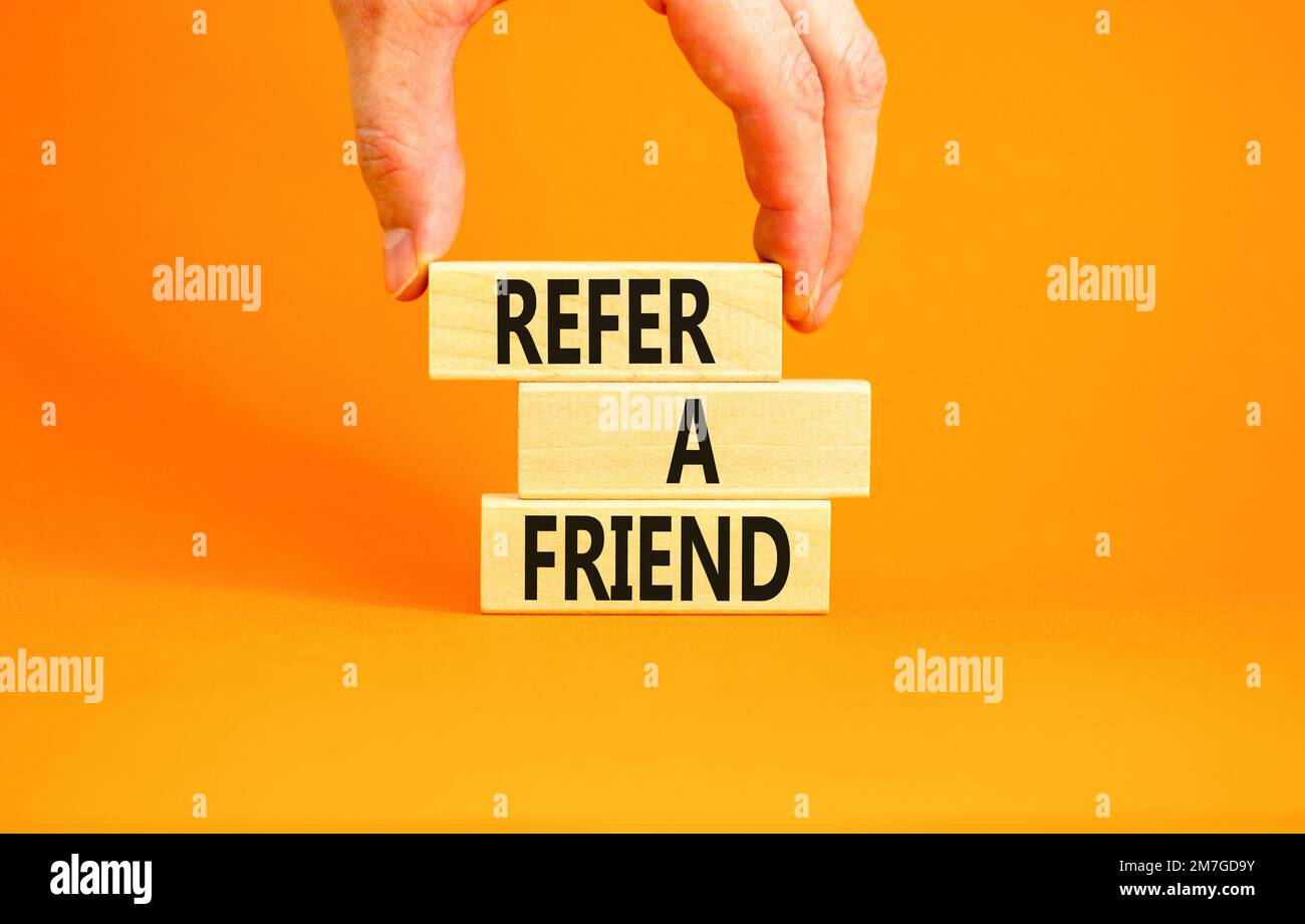 Refer a friend symbol. Concept words Refer a friend on wooden blocks on ...
