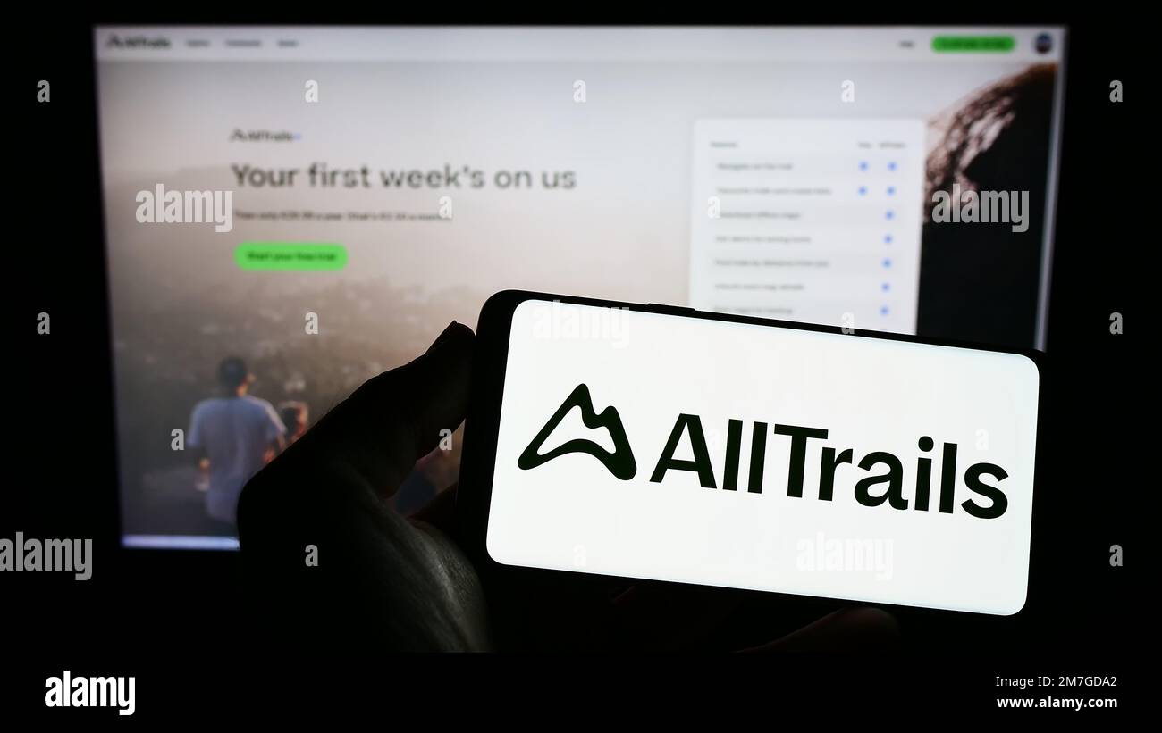 Person holding smartphone with logo of US outdoor platform company ...