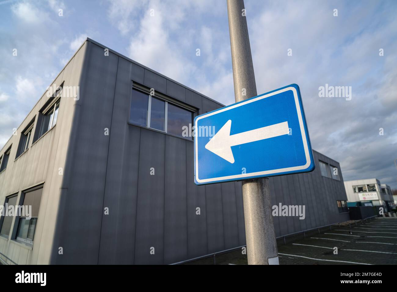 one way traffic sign along an industrial building Stock Photo - Alamy