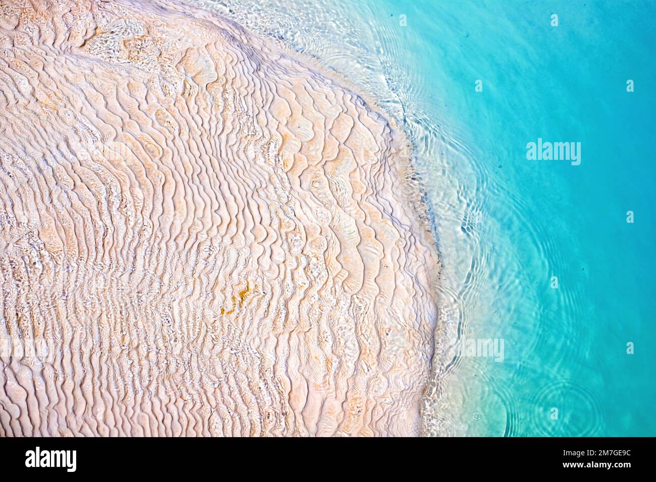 View of natural terraces in Pamukkale on a summer day. Close-up texture ...