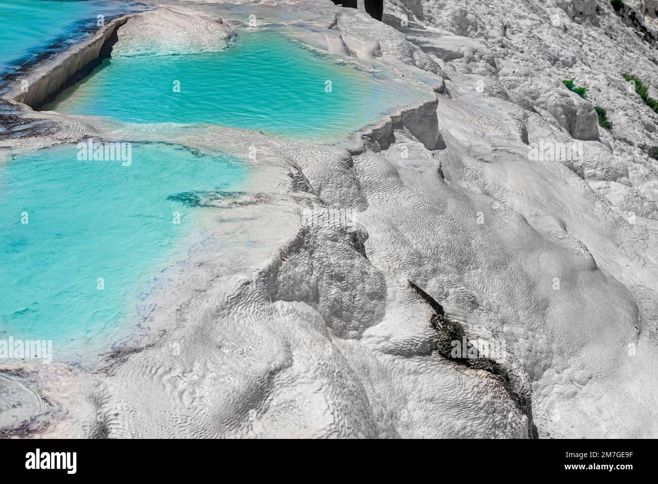 View of natural terraces in Pamukkale on a summer day. Close-up texture ...