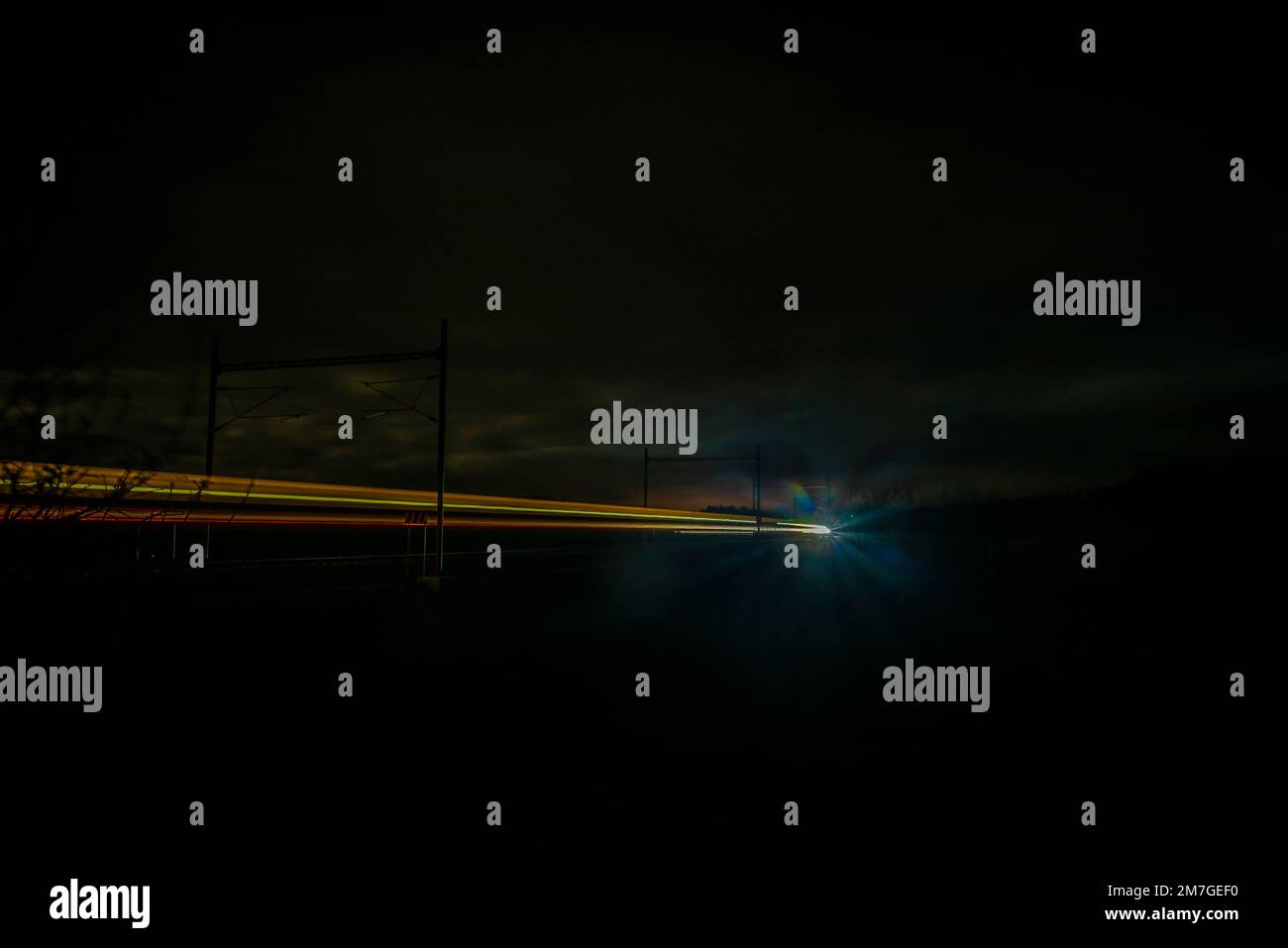 NIght dark color train lines in night between Prague and Tabor towns in ...