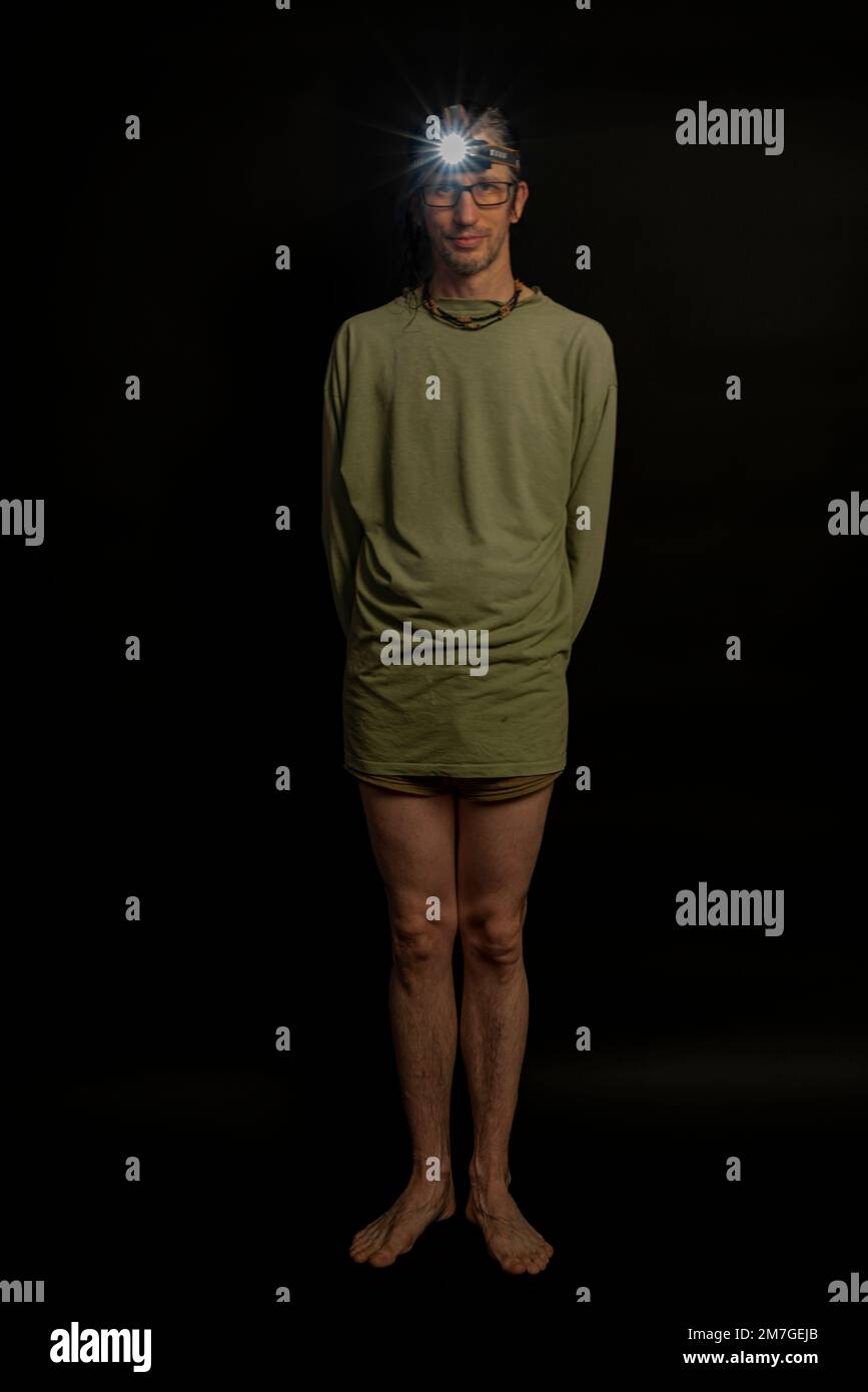 Slim man in army green boxer shorts and with switch on head lamp Stock ...