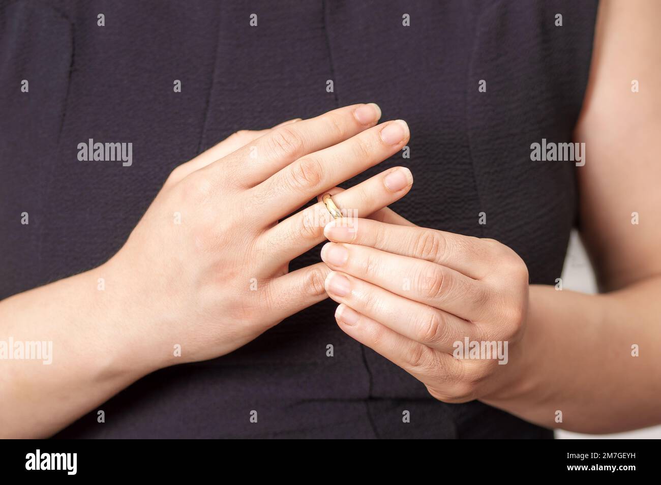 Woman taking off wedding ring hi-res stock photography and images - Alamy