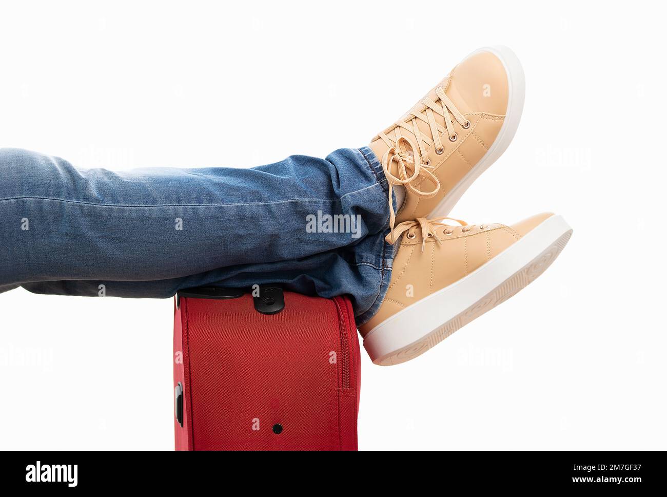 Detail of person resting with legs over the baggage with white ...