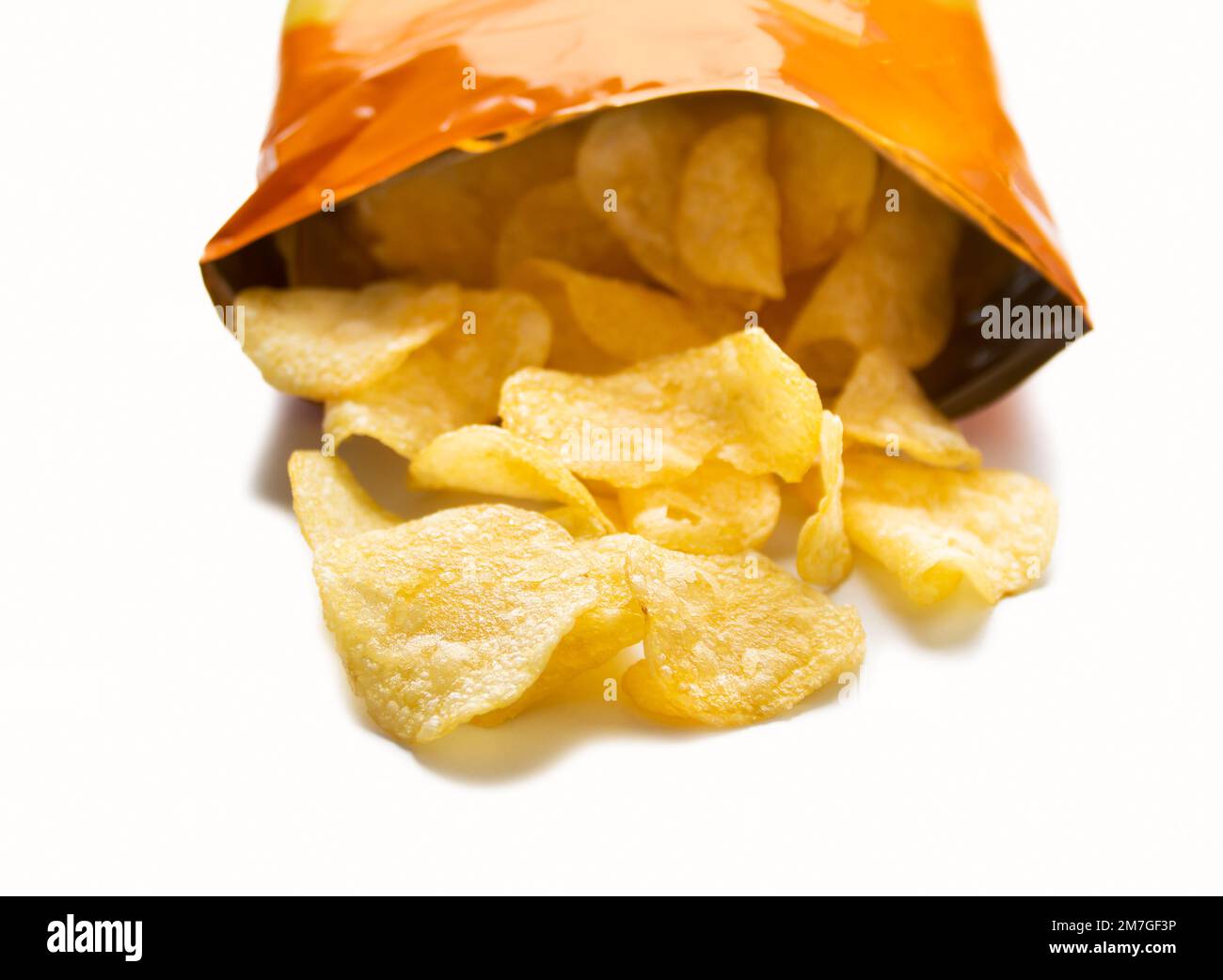heap of potato crisps on white background Stock Photo - Alamy