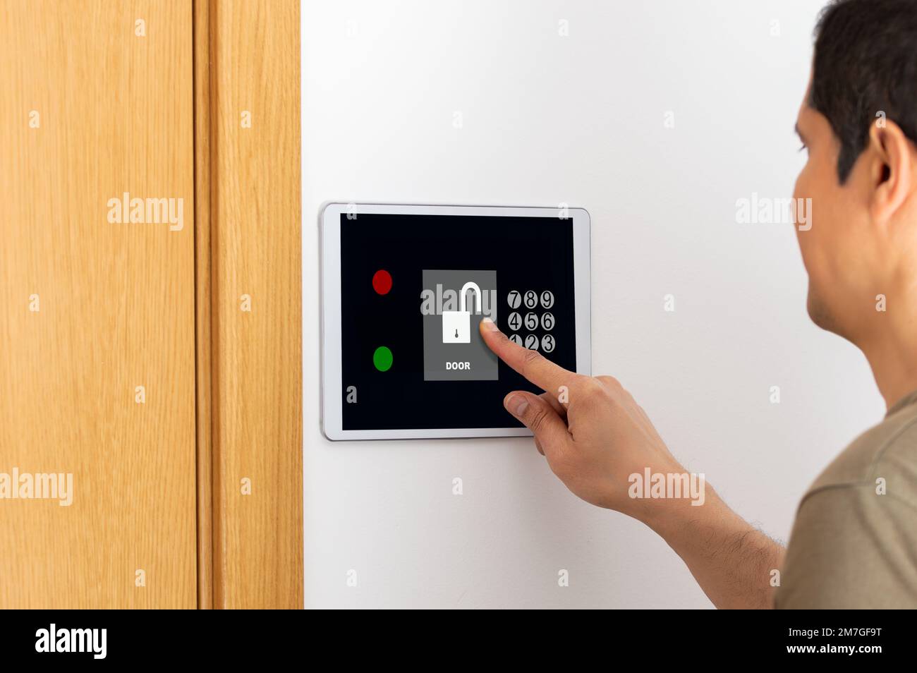 Man entering authorization code pin on home alarm keypad. Home security ...