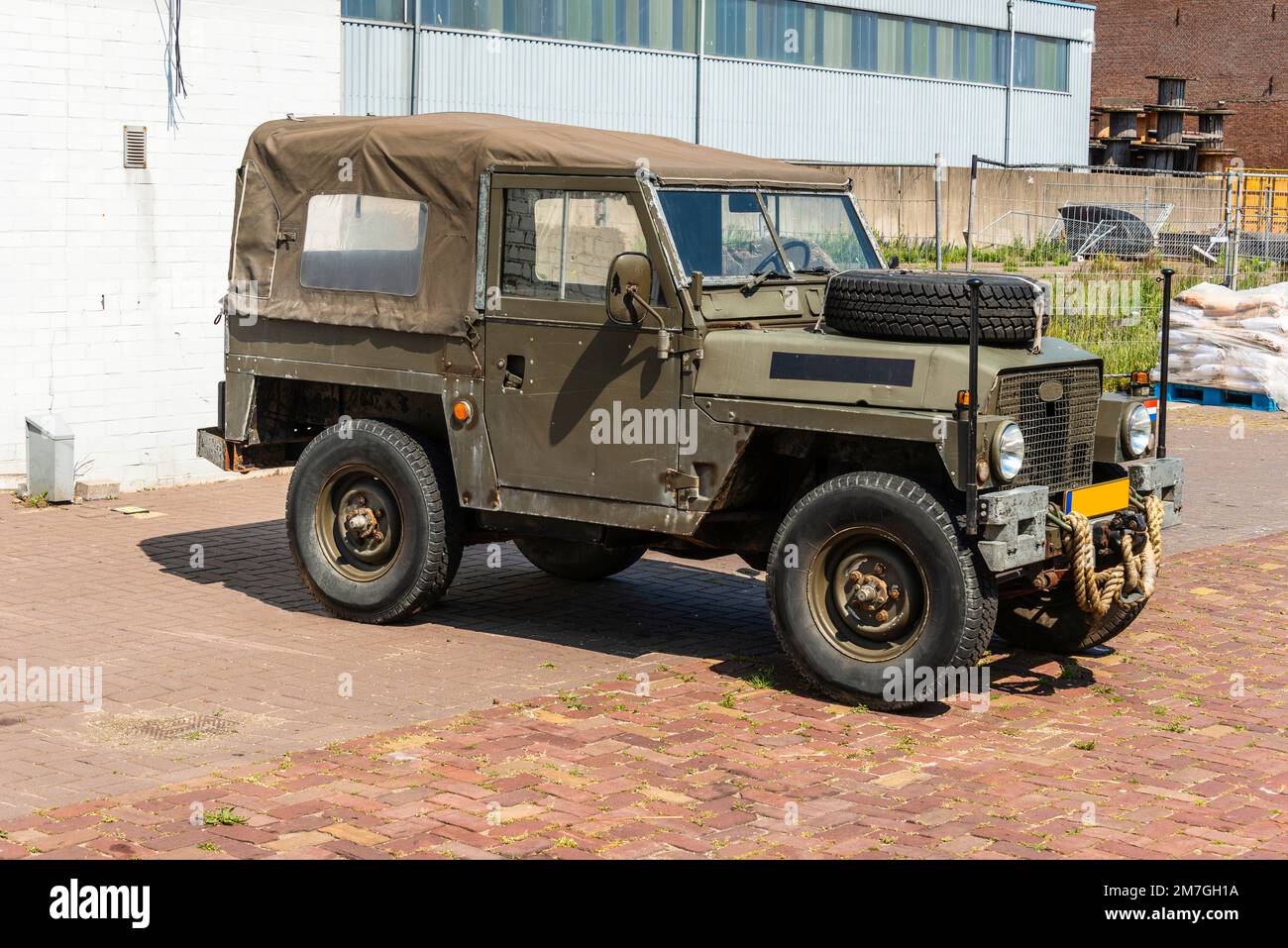 old green army land rover parked in an industrial area Stock Photo - Alamy