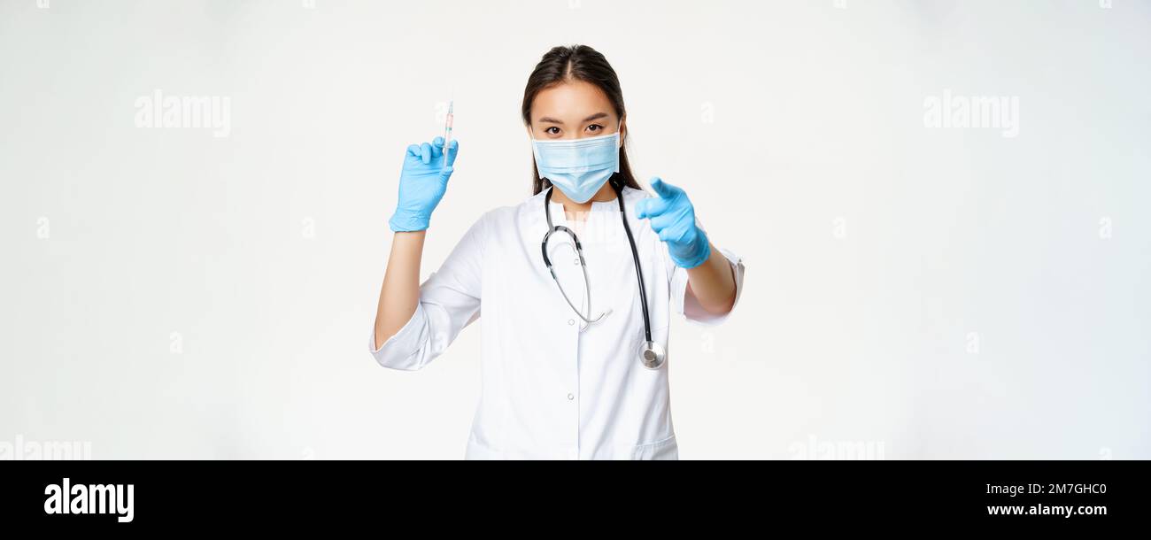 Coronavirus vaccination. Asian physician, doctor holding vaccine ...