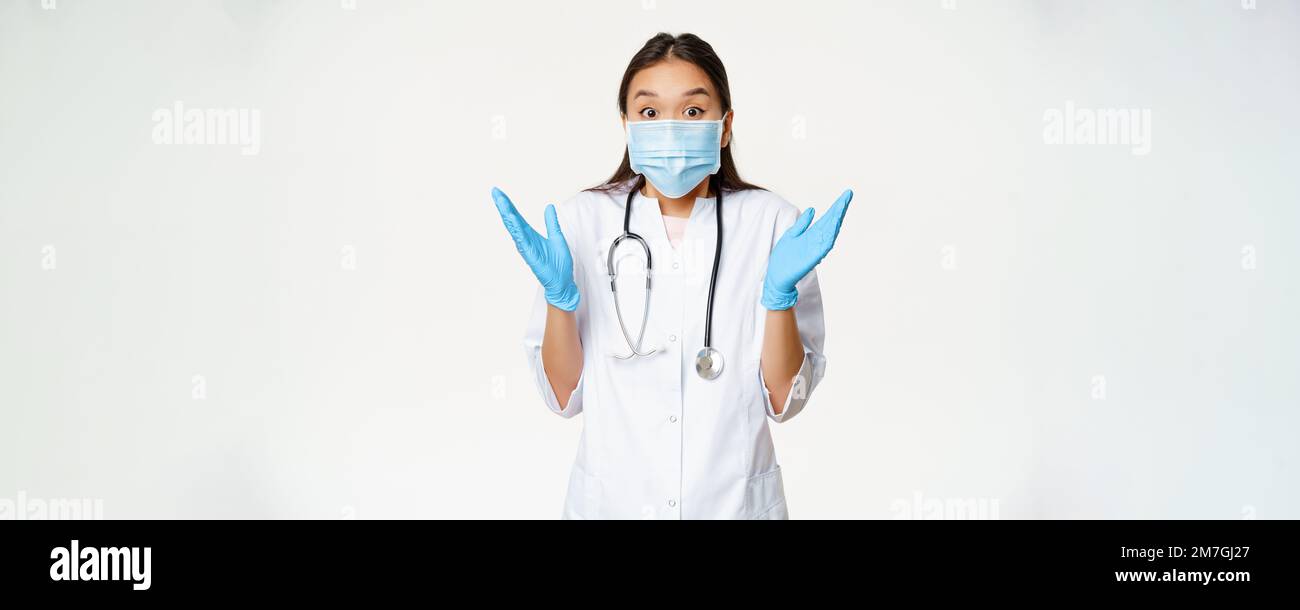 Portrait of happy asian female doctor clap hands, looking enthusiastic ...