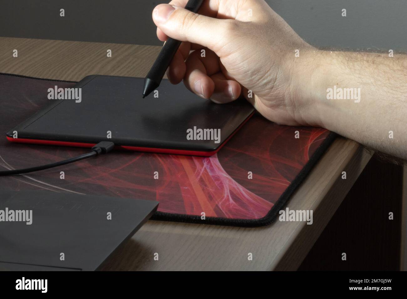 Graphic designer using a pen on a digital tablet Stock Photo - Alamy