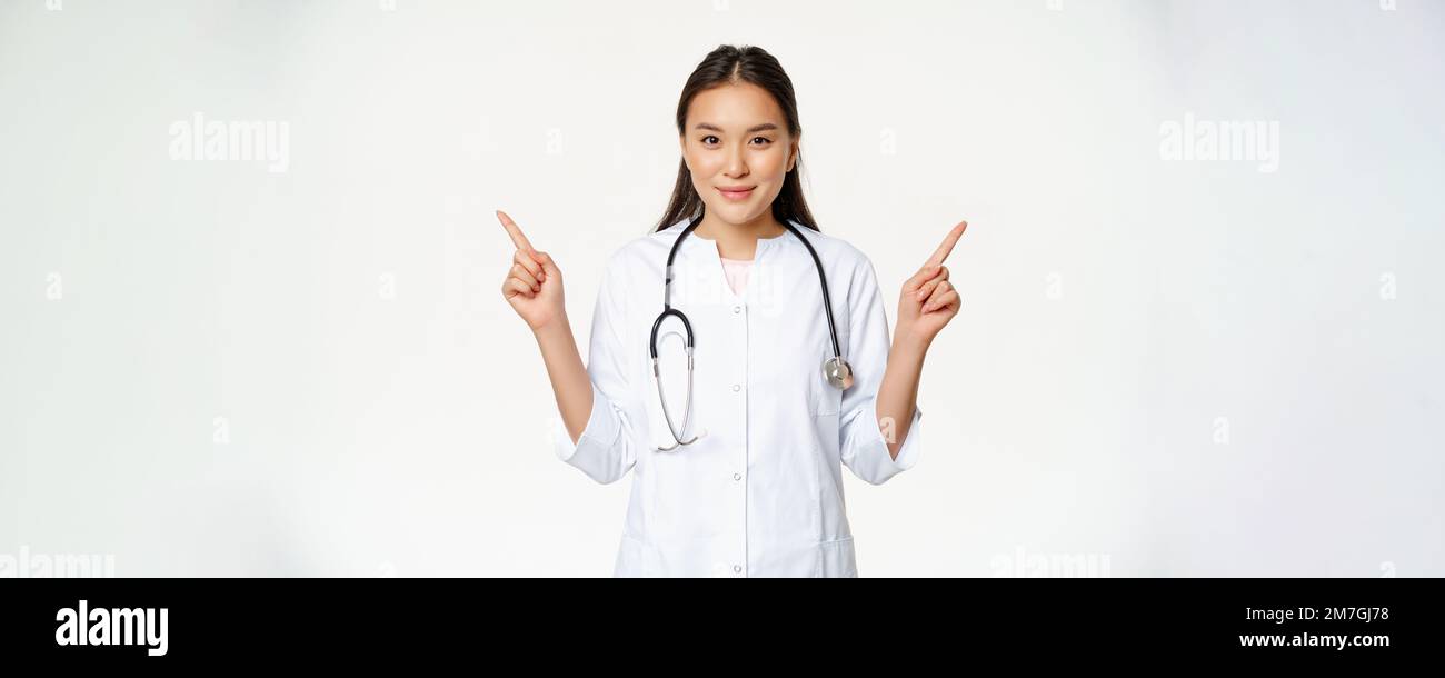 Portrait of asian female doctor, young healthcare worker in medical ...
