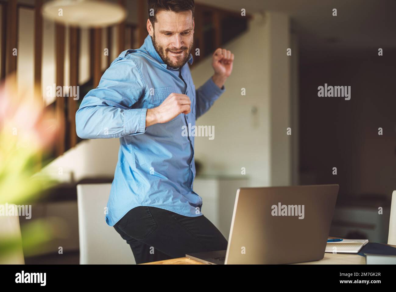 Excited caucasian man dancing happily while looking a football game on ...