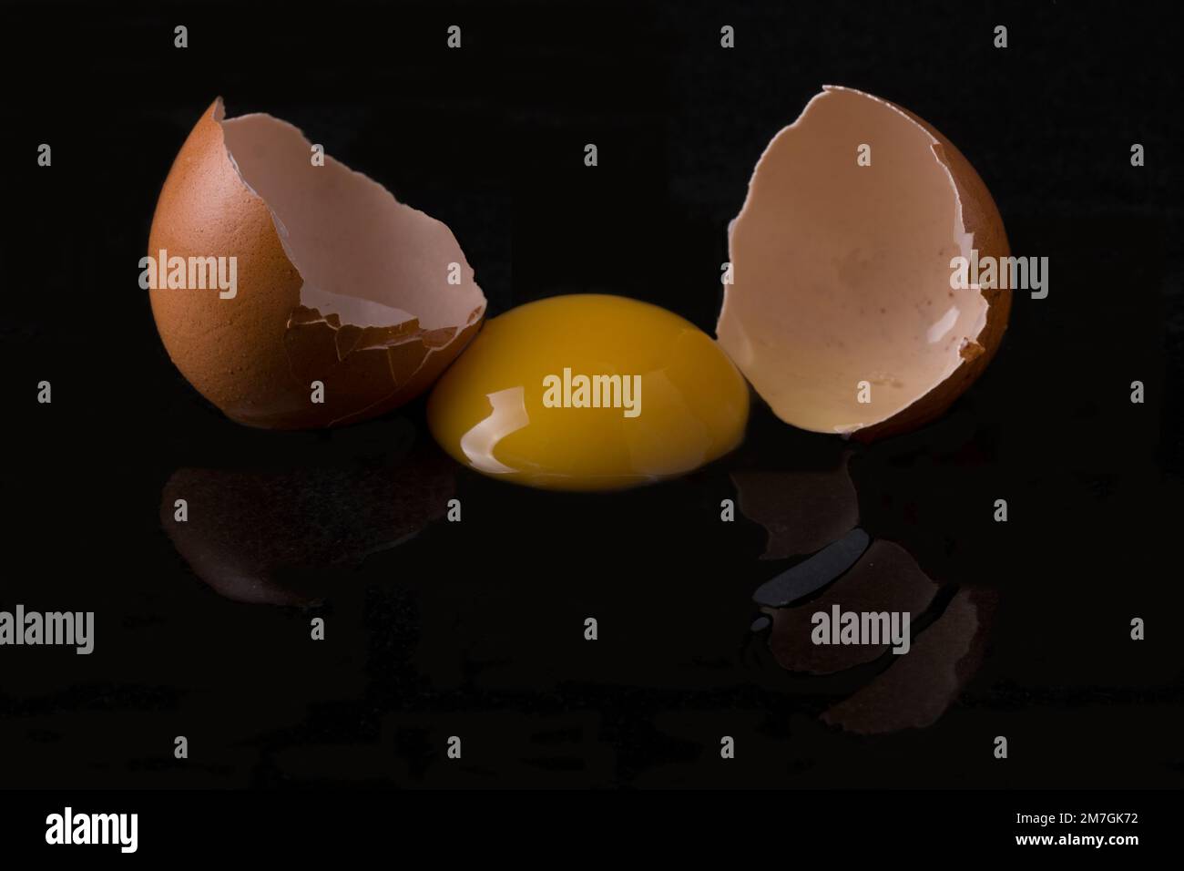 Raw Egg Cracked Open Shell Yolk Stock Photo - Alamy