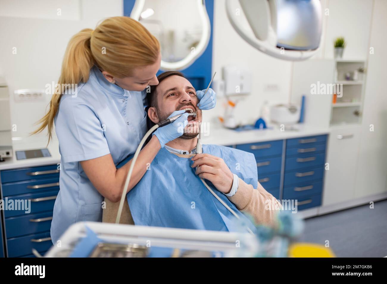 Woman dentist at work with patient.Dental care,taking care of teeth ...