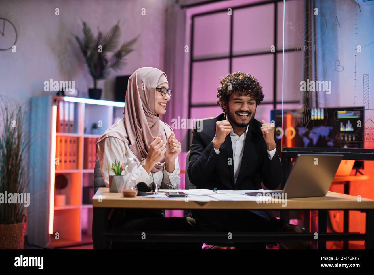 Overjoyed multiracial business people, muslim businesswoman and male ...