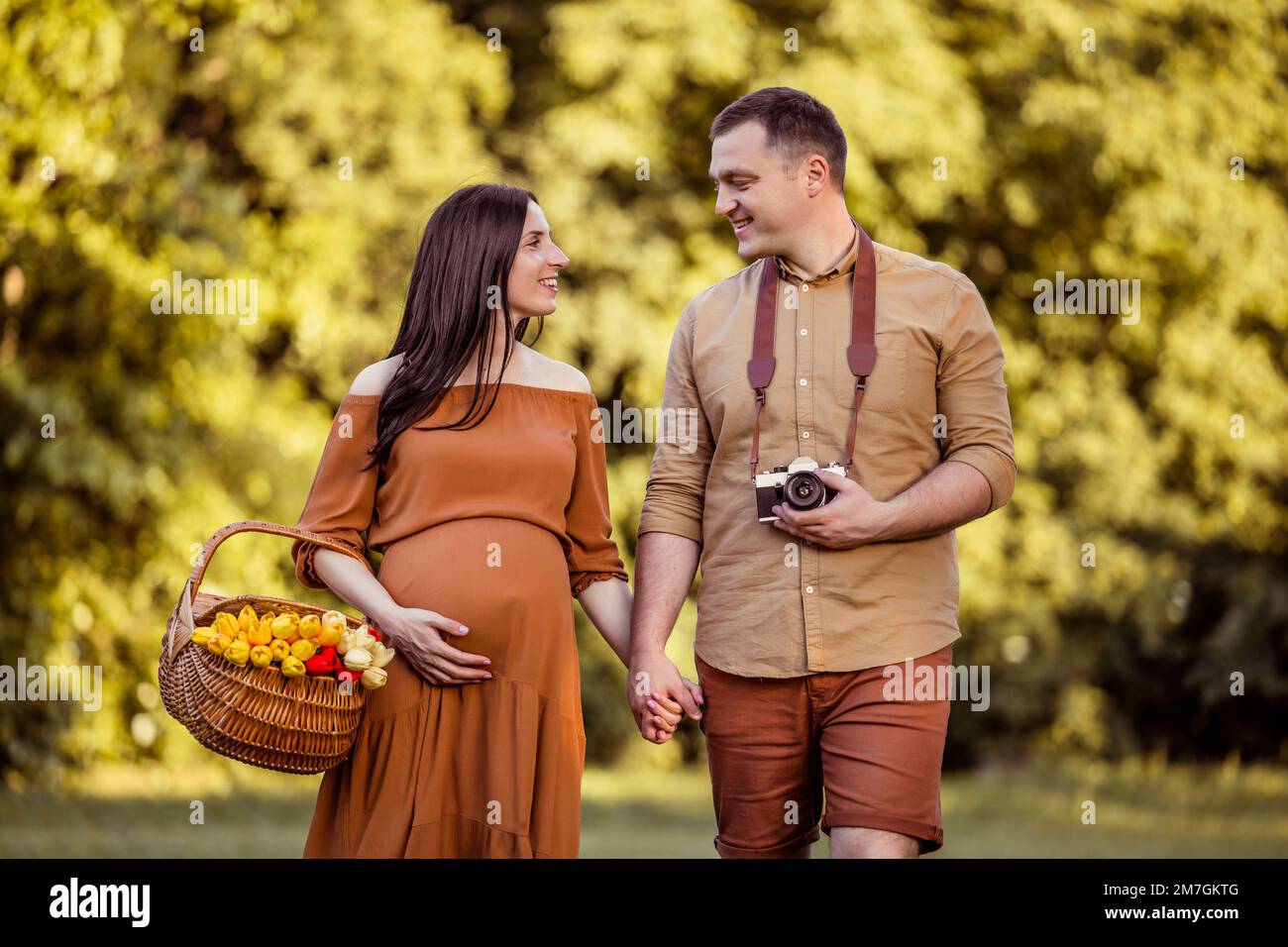 Happy pregnant couple enjoying in nature.Husband with his pregnant wife ...