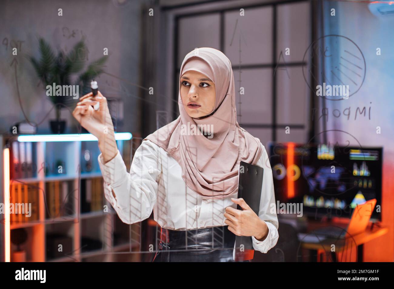 Confident female ceo manager, writing tasks or new startup ideas on ...