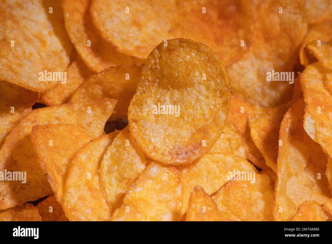 tasty crispy potato chips background Stock Photo - Alamy
