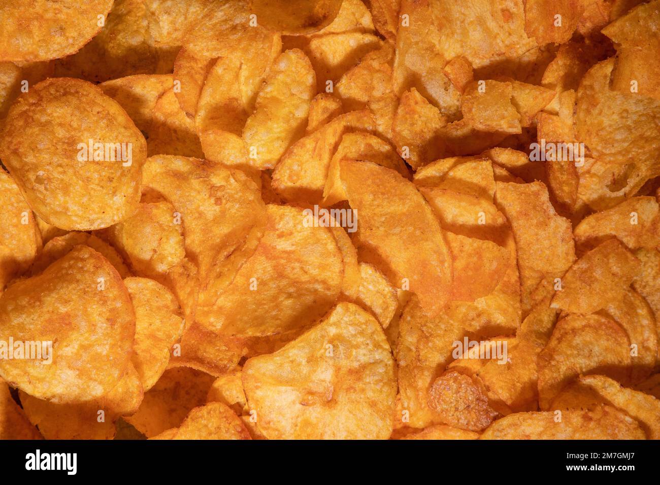 tasty crispy potato chips background Stock Photo - Alamy