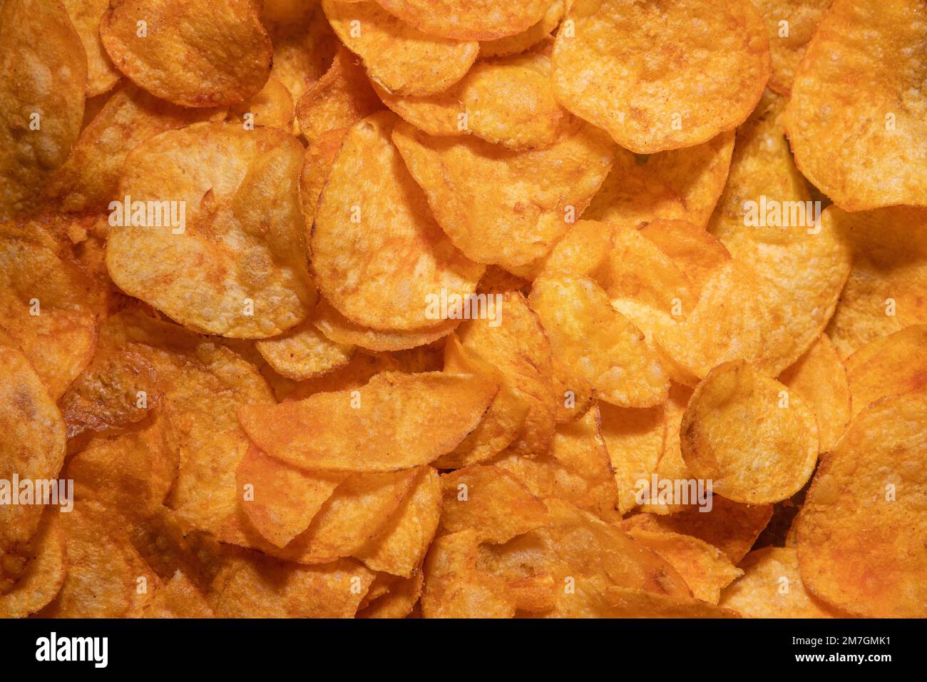tasty crispy potato chips background Stock Photo - Alamy