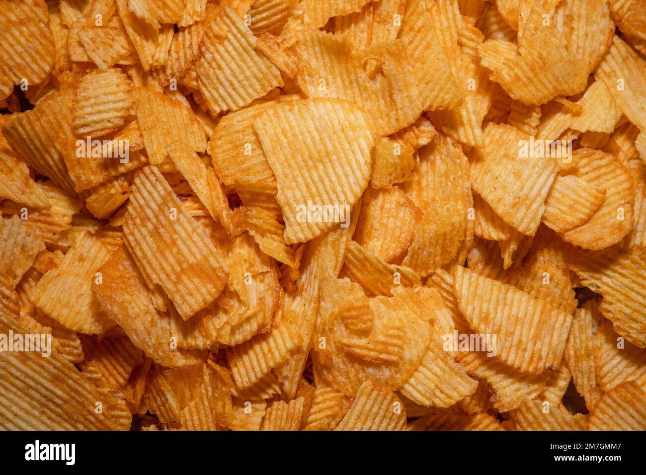 tasty crispy potato chips background Stock Photo - Alamy
