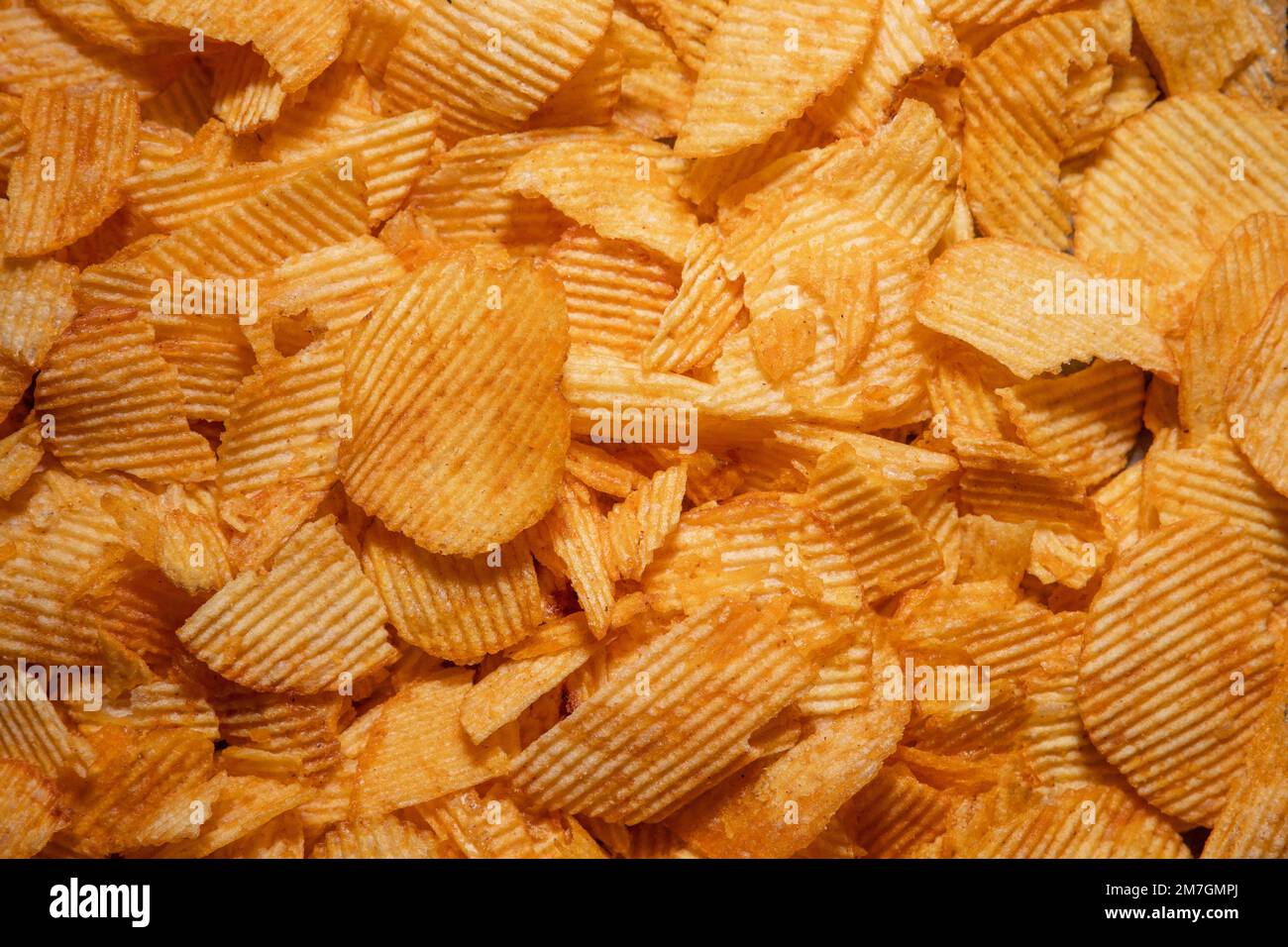 tasty crispy potato chips background Stock Photo - Alamy