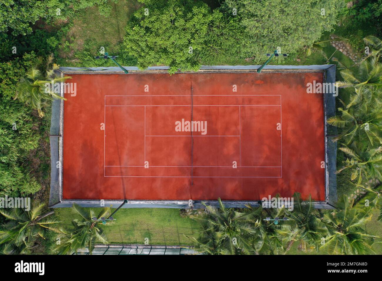 An aerial view of a tennis field surrounded by beautiful trees Stock ...