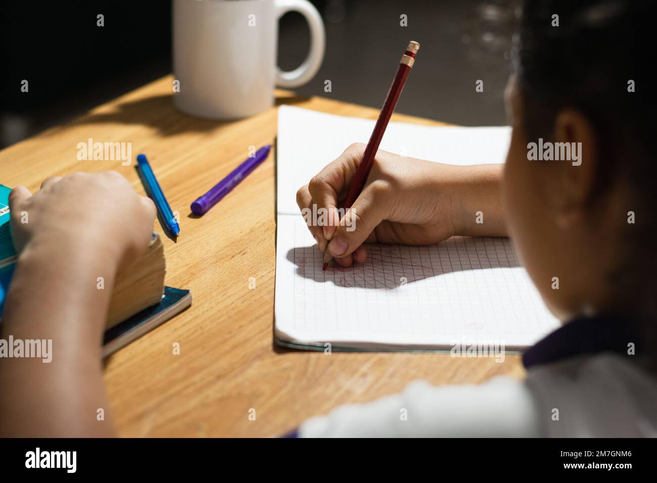 detailed view of a little latin girl's hands painting with her red ...