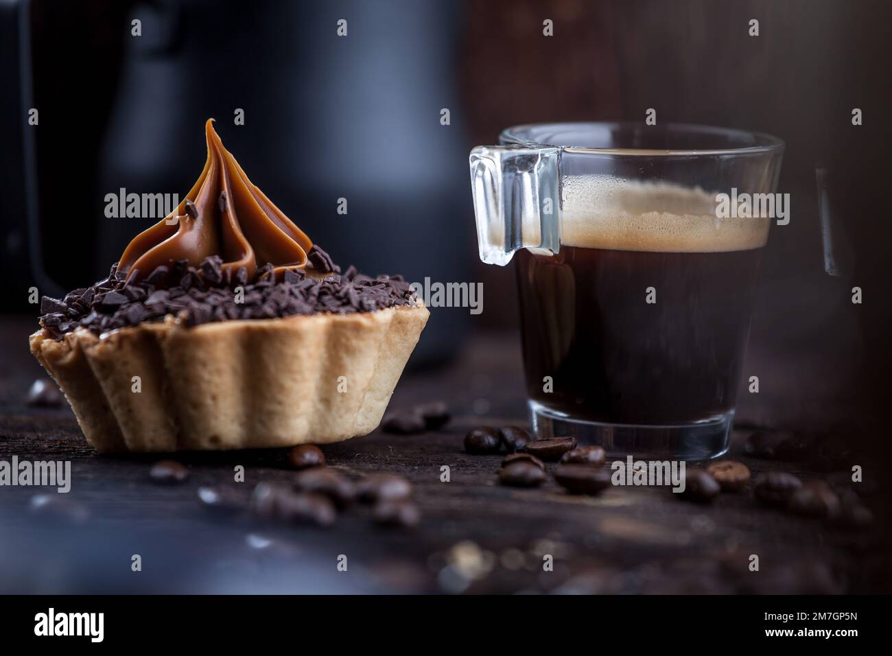 Aromatic freshly brewed coffee on a background of coffee beans and ...