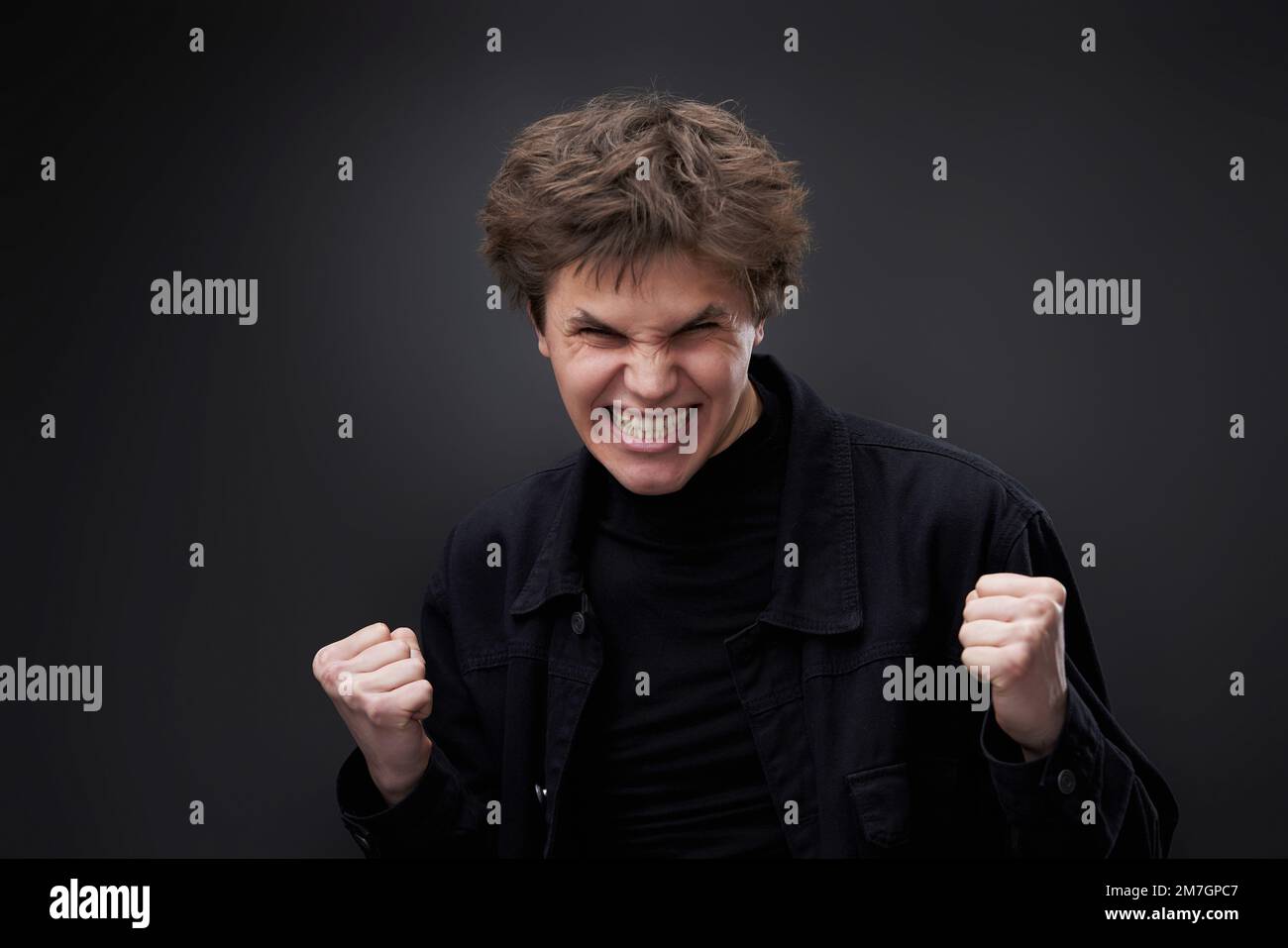 annoyed angry man in furious gesture on black background Stock Photo ...