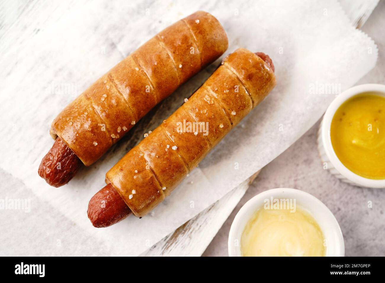 Pretzel hot dogs served with sauce, selective focus - Game day snacks ...