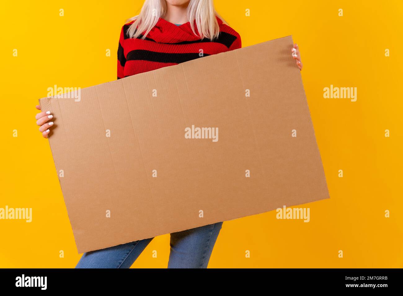 Holding empty cardboard advertisement poster, blonde caucasian girl on ...