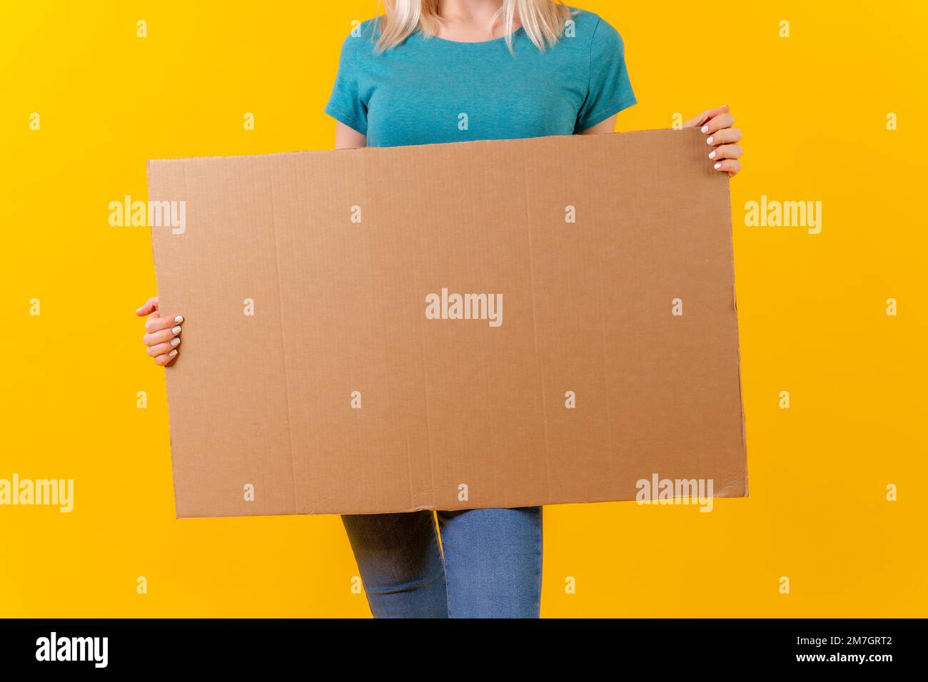 Holding empty cardboard advertisement poster, blonde caucasian girl on ...