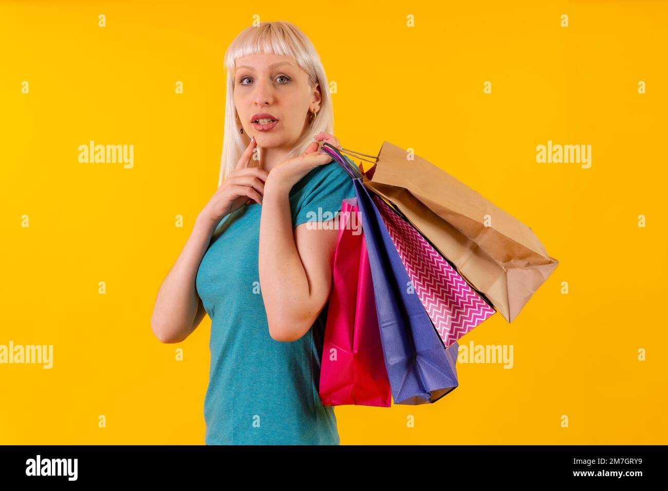 Thinking shopping with bags in the sales, blonde caucasian girl in ...