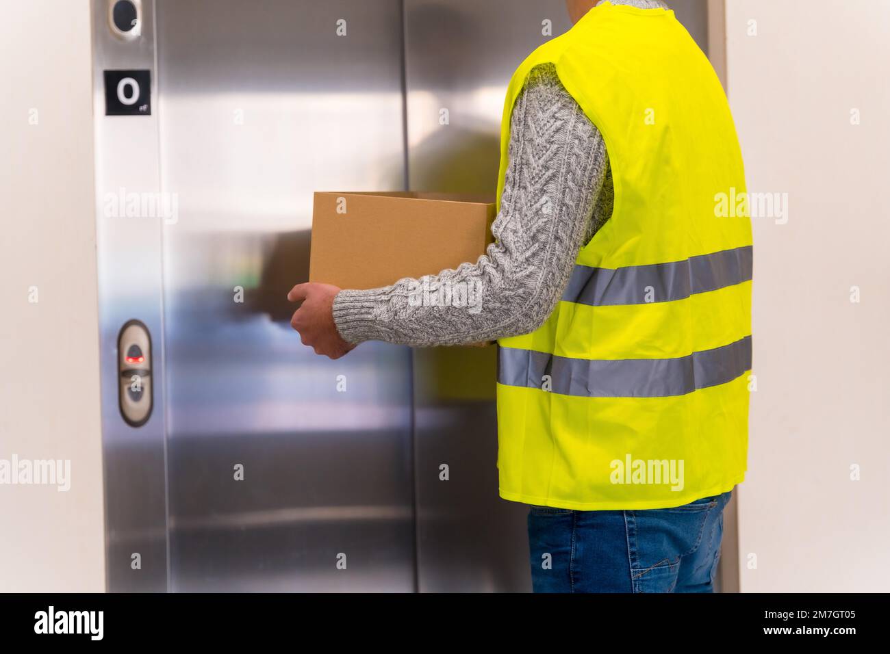 Young delivery man in protective uniform at online order delivery ...