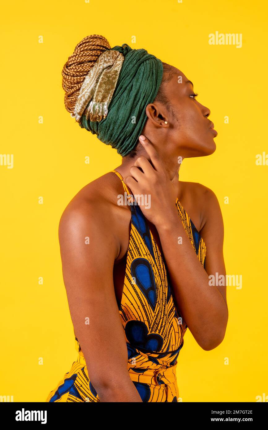 A person woman of black ethnicity with traditional costume on yellow ...