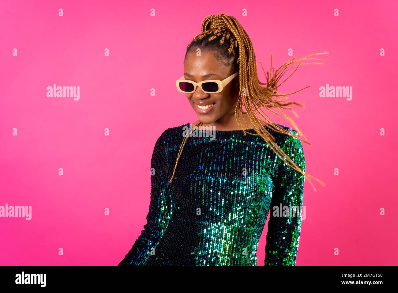 Black ethnic woman with braids party dancing on pink background ...