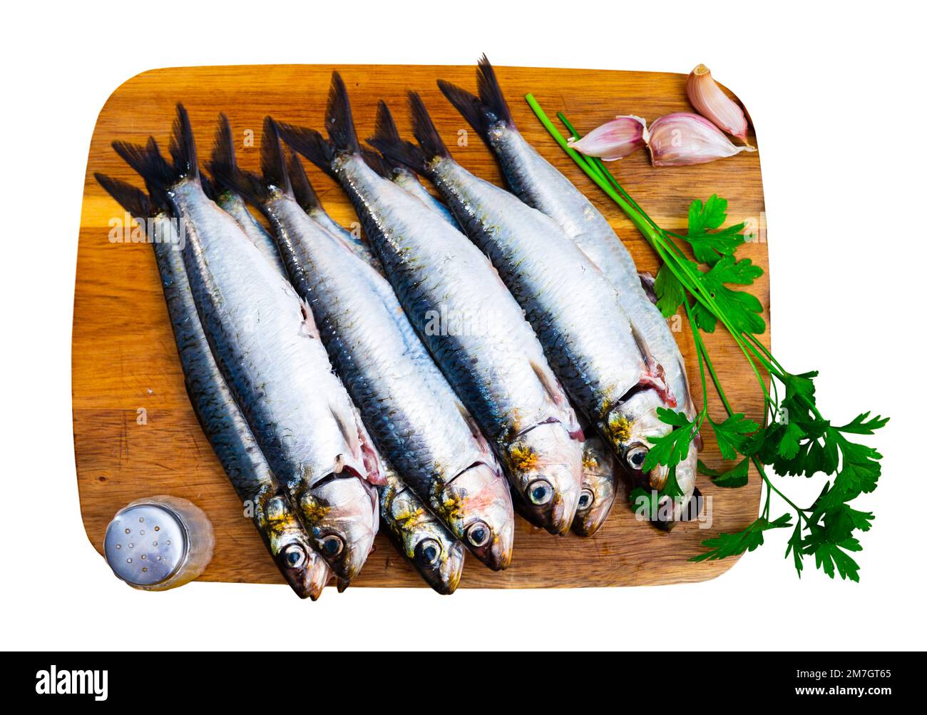 Raw sardines on wooden board with parsley, garlic, lemon and oil Stock ...