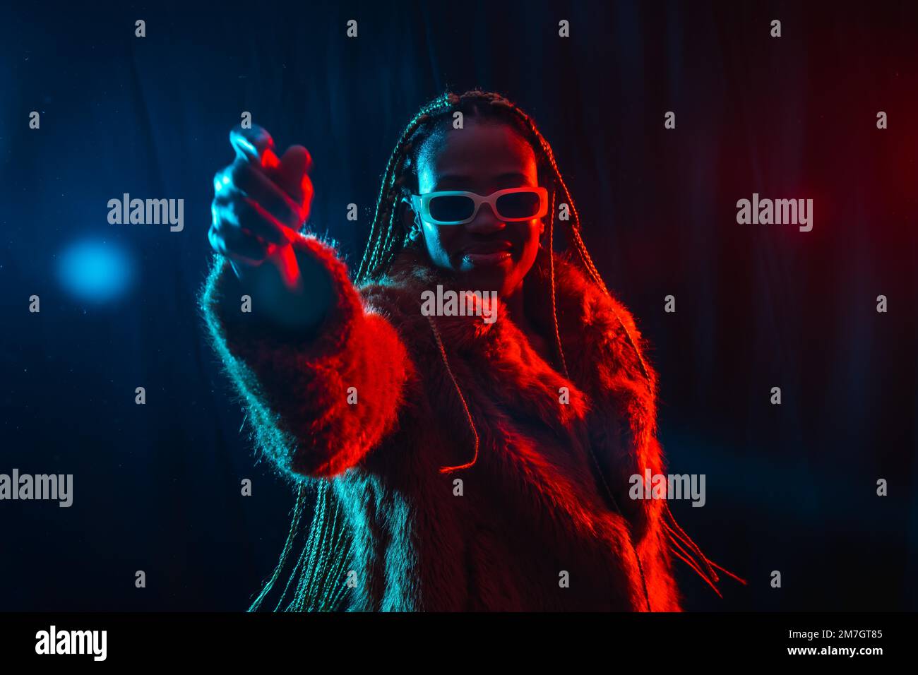 Young african woman with braids with blue and red led lights, trap ...