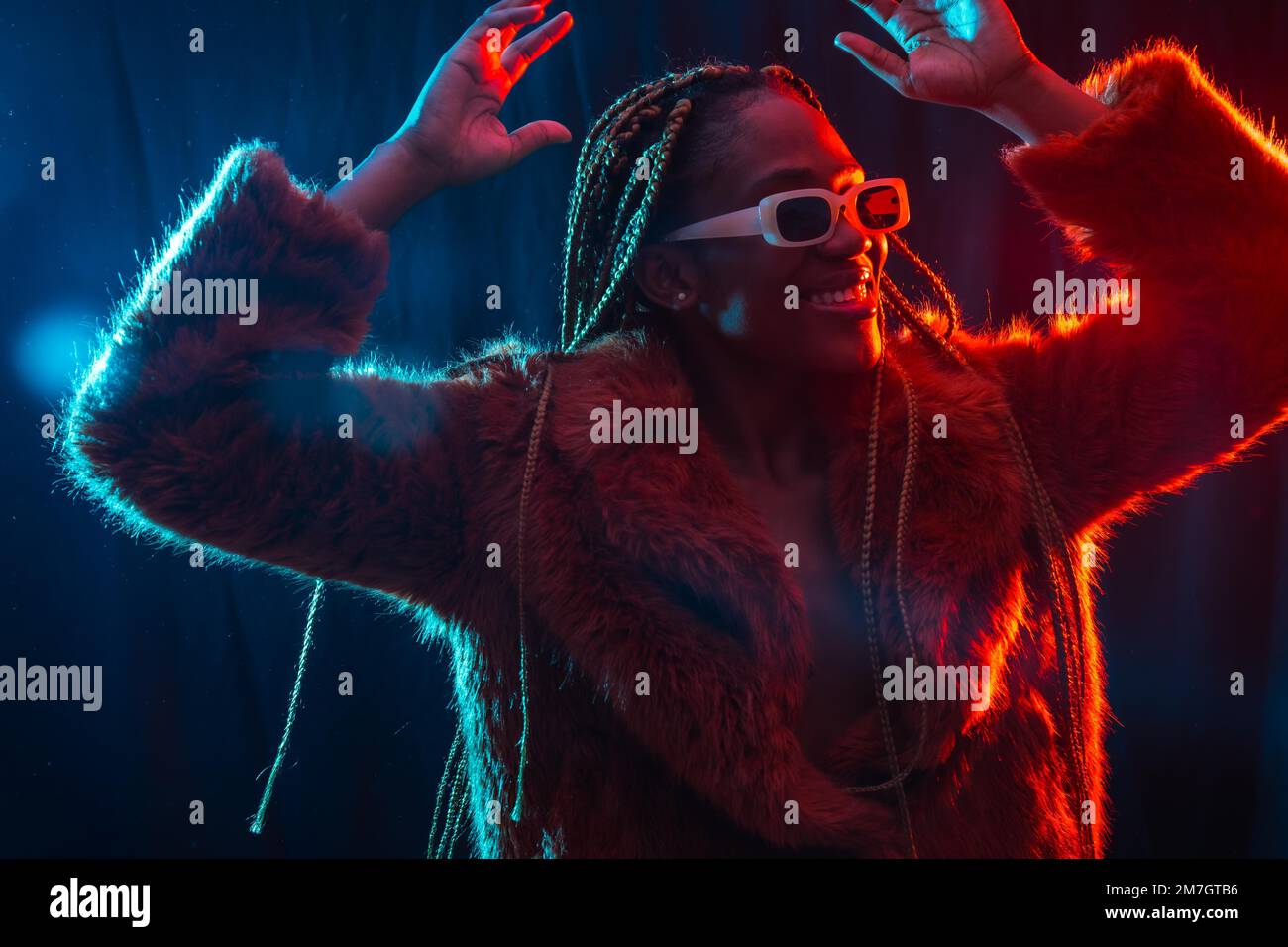 African young woman with braids with blue and red led lights, trap ...