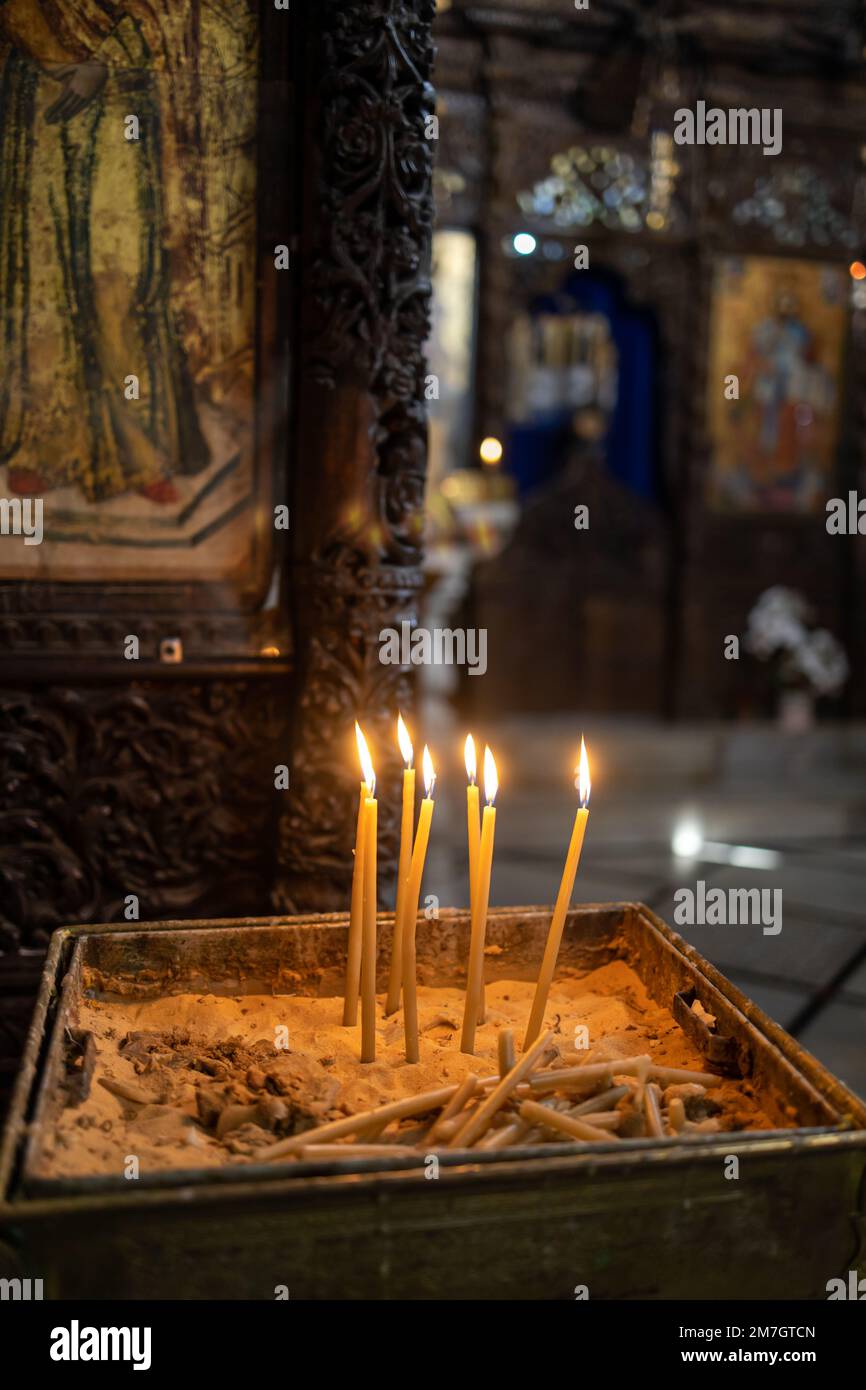 Candels in church. Religious spiritual concept. Candles in a tray with ...