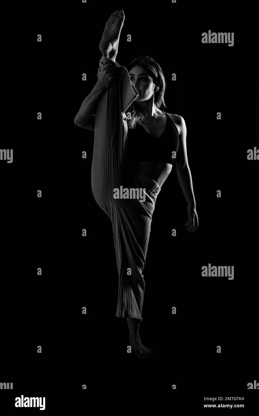 Young dancer in studio photo session with a black background, ballet ...