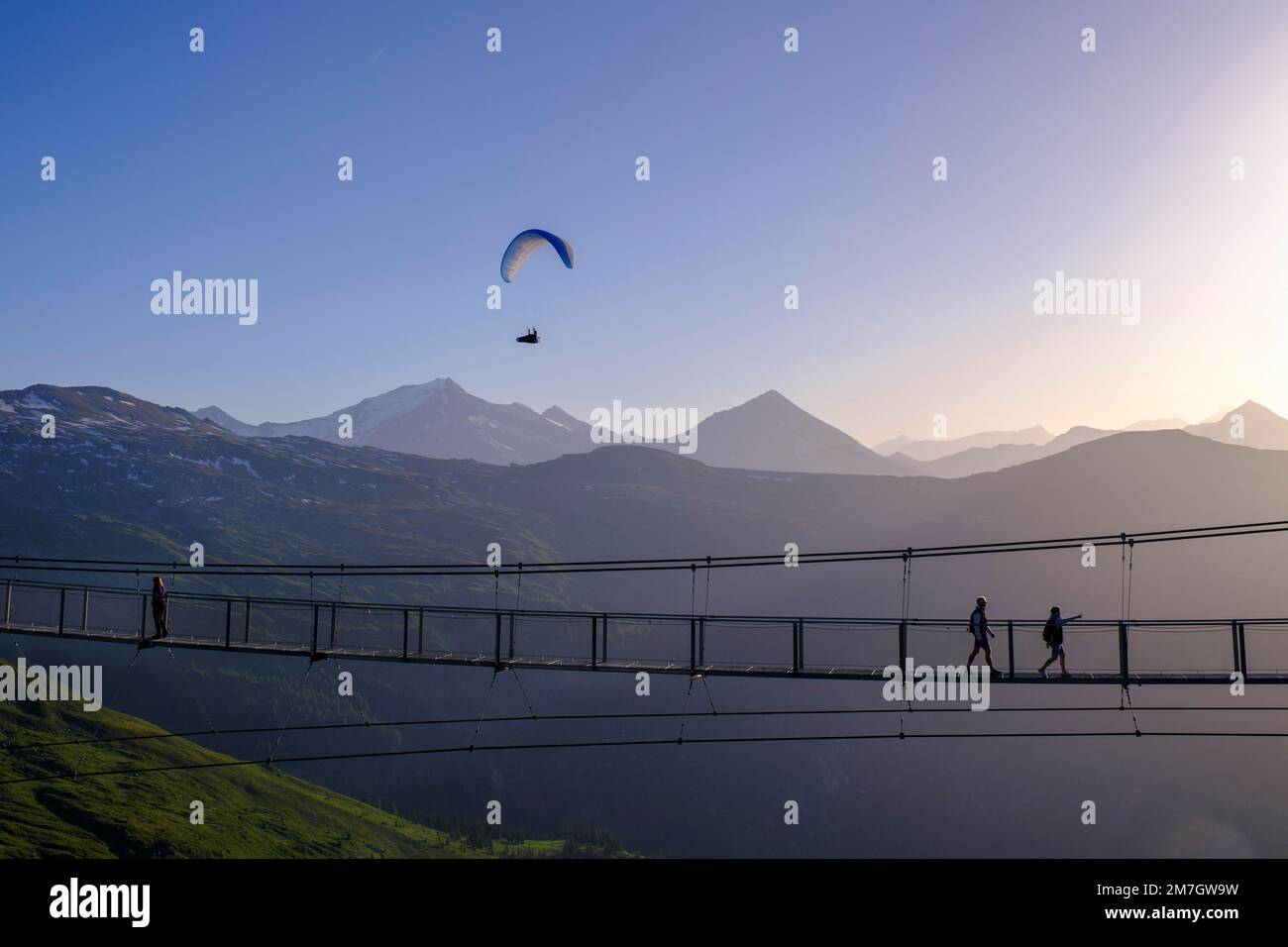 Suspension bridge with paraglider, sunset at Stubner Kogel, Bad Gastein ...