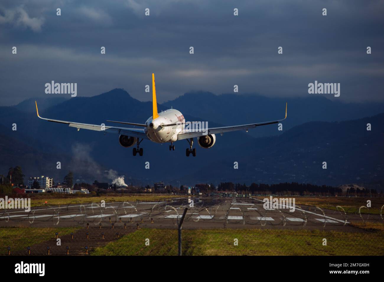 Airplane landing mountains on background hi-res stock photography and ...