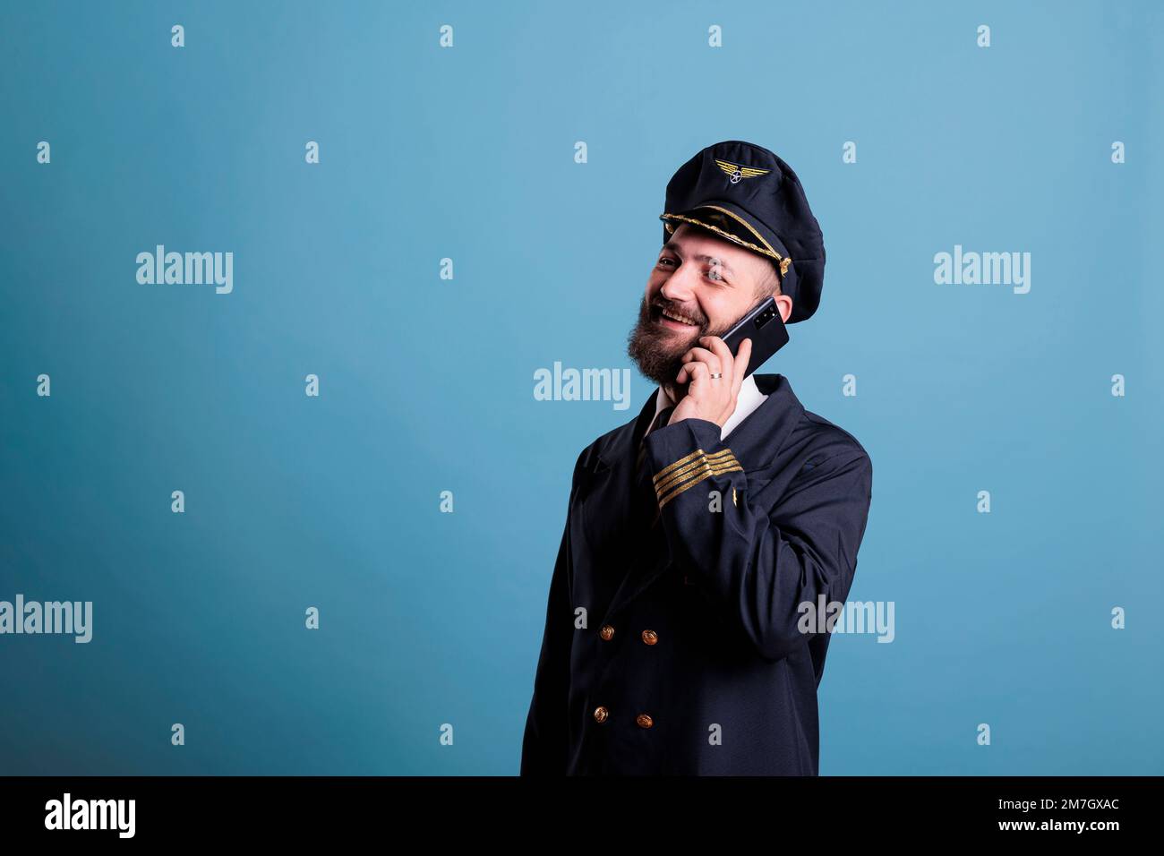 Middle aged captain talking on modern phone, holding smartphone, having ...