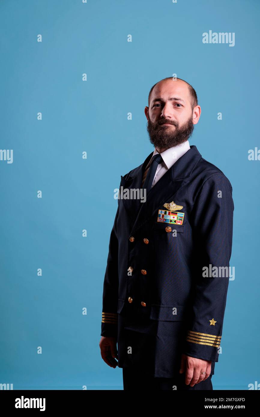 Airplane captain standing in professional uniform portrait, confident ...