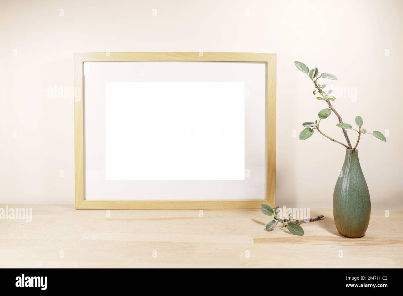 Empty horizontal frame with passe-partout as mock-up and a vase with ...